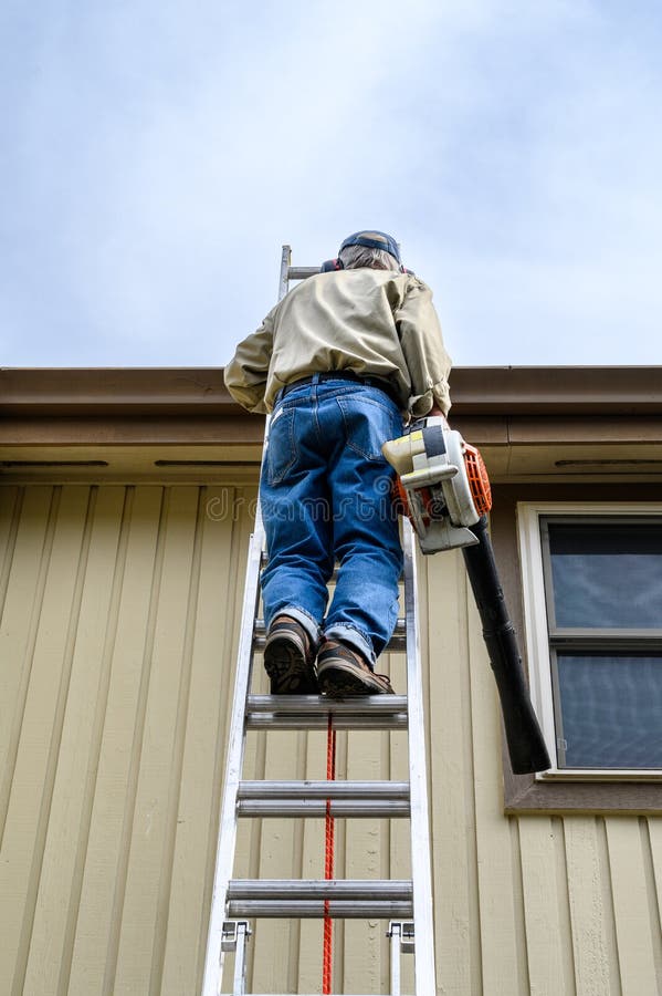 Closeup of a Senior Man Climbing a Ladder with a Leaf Blower, Fall ...