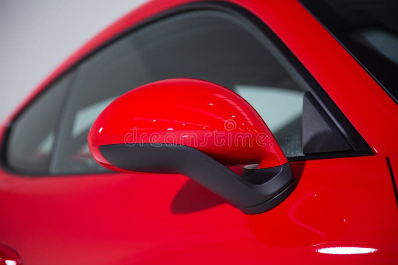 Closeup of the Shiny Side-view Mirror of a Red Luxury Car Under the ...