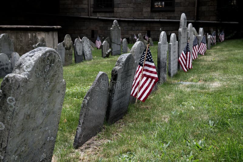 Closeup Shot of an American Graveyard with US Flags Next To Headstones ...