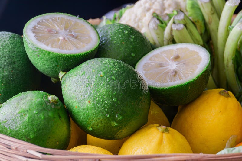 Closeup Shot of a Basket Full of Lemons and Wet Green Lemons Stock ...