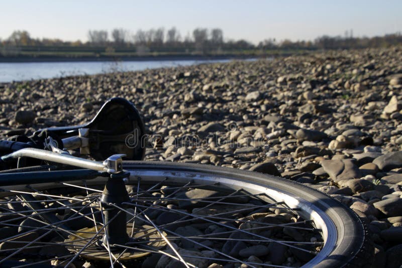 Closeup Shot of a Bicycle Lying Down Sideways on a Beach Stock Image ...