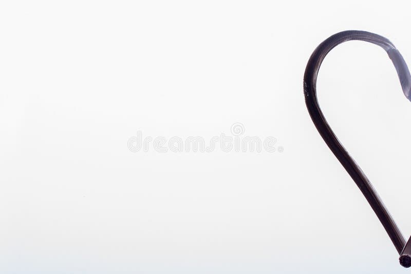 Closeup Shot of a Black Hook on a White Background Stock Photo - Image ...