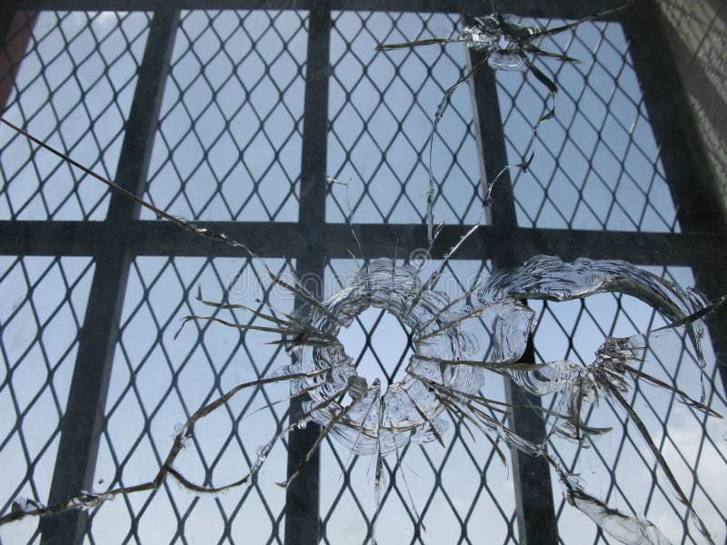 Closeup Shot of Broken Window Glass with Bullet Holes Stock Image ...