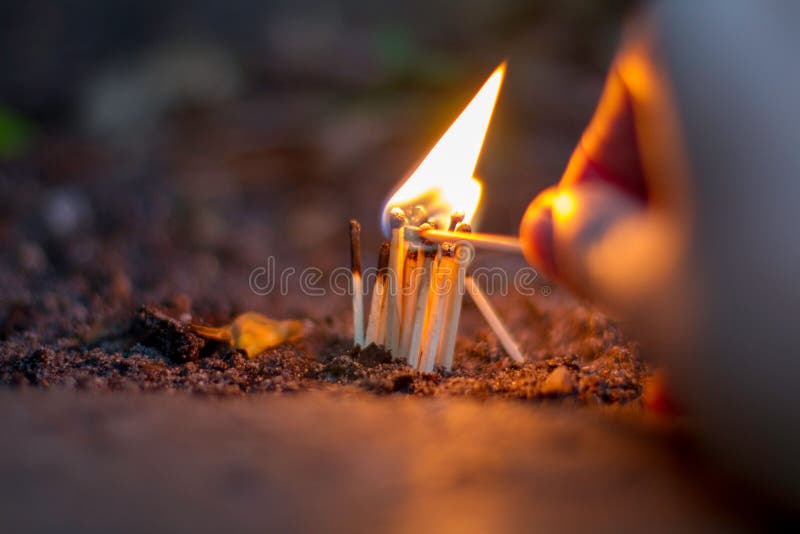 Closeup Shot of a Bunch of Matches Stuck Onto a Surface and a Hand ...