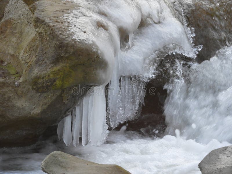 Cascade of Melting Icicles on a Cliff Face Stock Photo - Image of frost ...