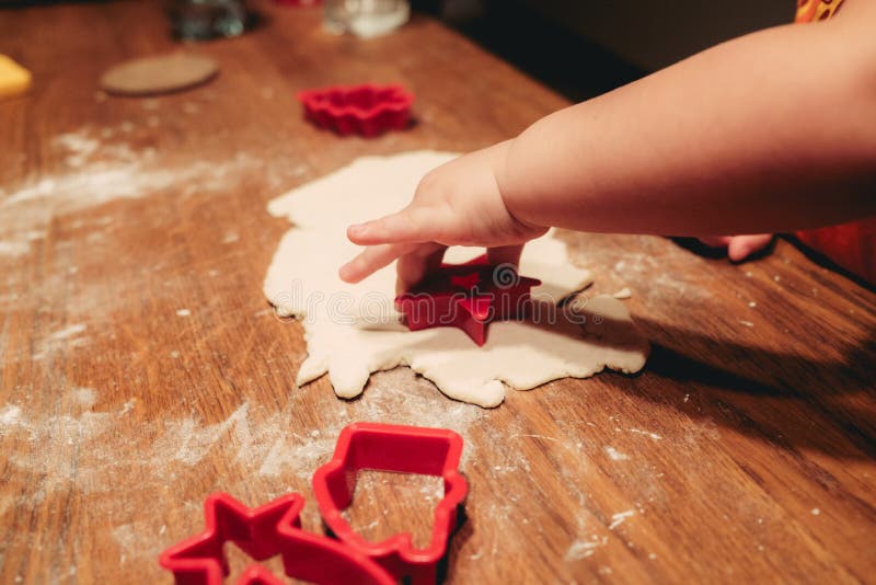 Closeup Shot of a Child Using Cookie Cutters on the Dough Stock Photo ...