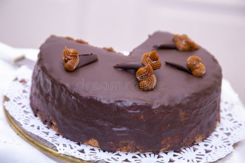 Closeup Shot of a Chocolate Cake with a Quarter Cut Stock Photo - Image ...