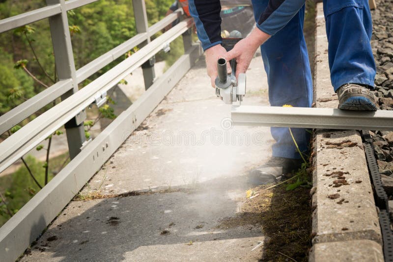 Closeup Shot of a Construction Worker Cutting Off a Piece of a Cable ...