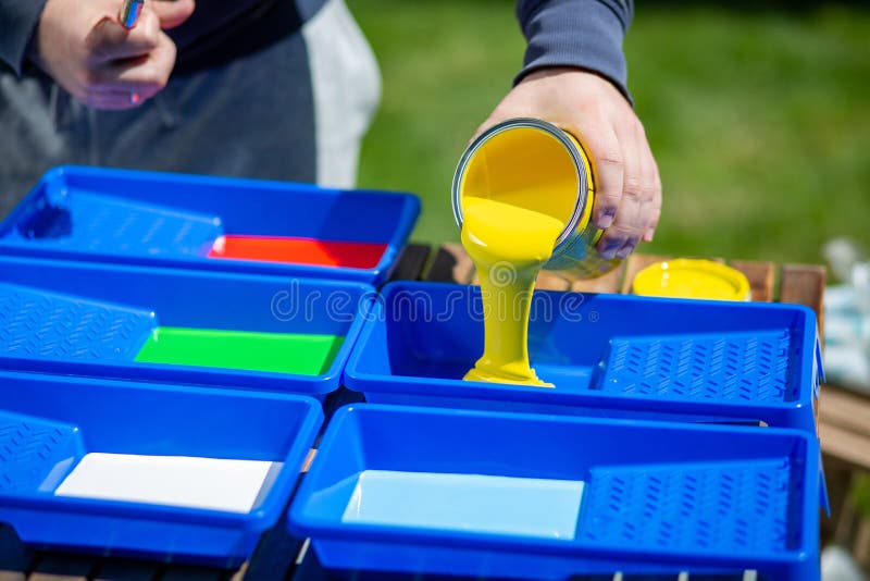 Closeup Shot of a Construction Worker Pouring Paint into Blue ...