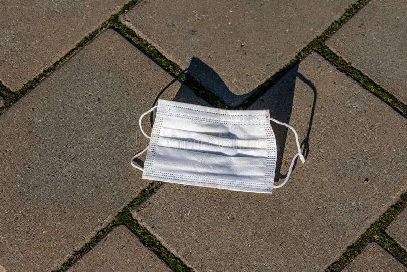 Closeup Shot of Dirty Face Mask on the Ground Stock Image - Image of ...
