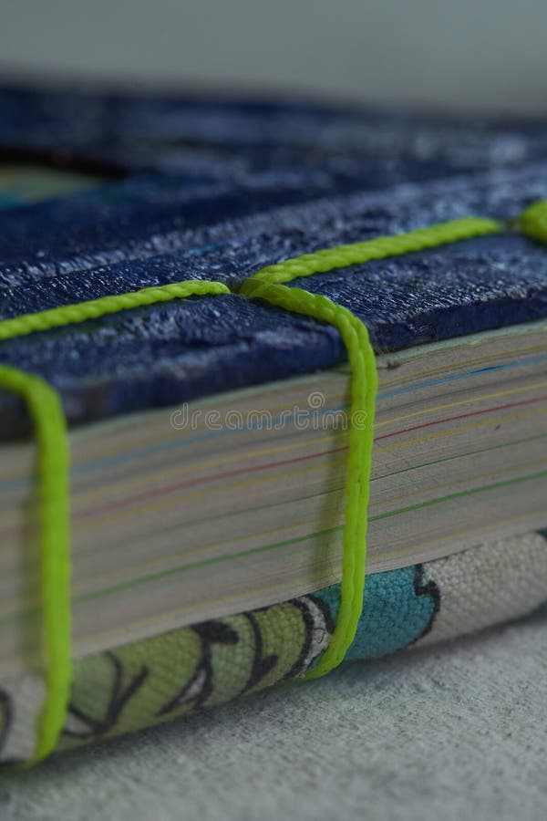 Closeup Shot of Folded Paper Sheets Bound with Green Thread Stock Photo ...