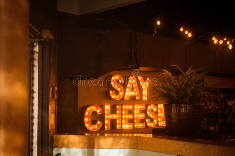 Closeup Shot of a Glowing Illuminated Say Cheese Sign Stock Photo ...
