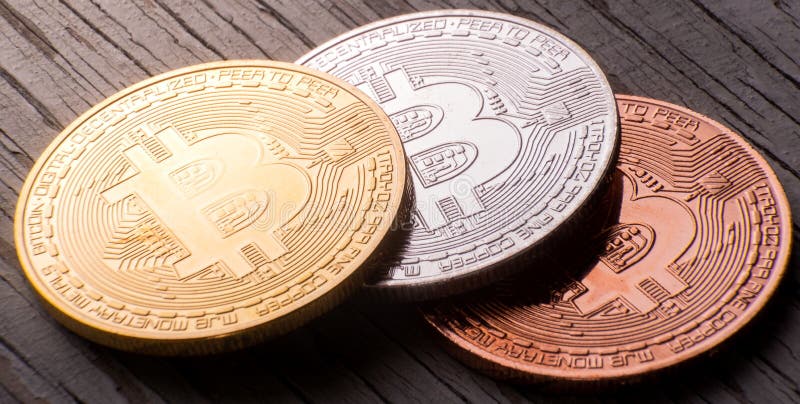 Closeup Shot of Gold, Silver, and Bronze Bitcoin in a Wooden Surface ...