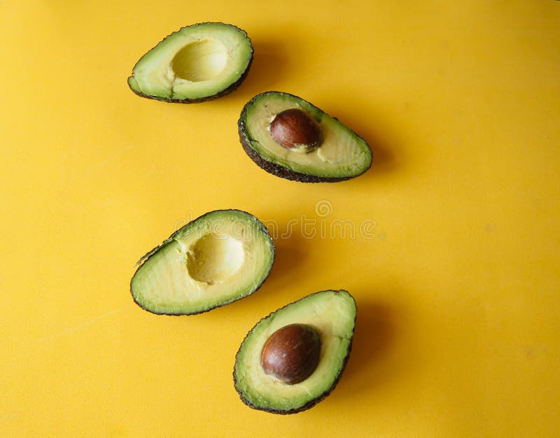 Closeup Shot of a Group of Avocados on a Yellow Background Stock Image ...