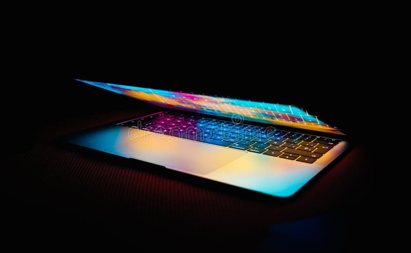 Closeup Shot of a Half-opened Laptop with Colorful Lights in a Dark ...
