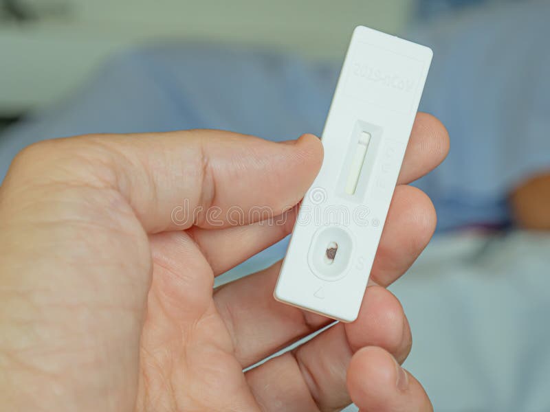 Closeup Shot of a Hand Holding a Negative Antigen Test Stock Photo ...