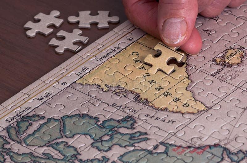 Closeup Shot of the Hands of a Retired Lady Solving a Puzzle of a Map ...