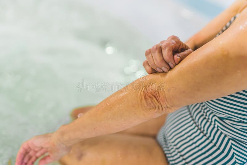 Closeup Shot of the Hands of a Senior Woman in a Bathing Suit on a Pool ...