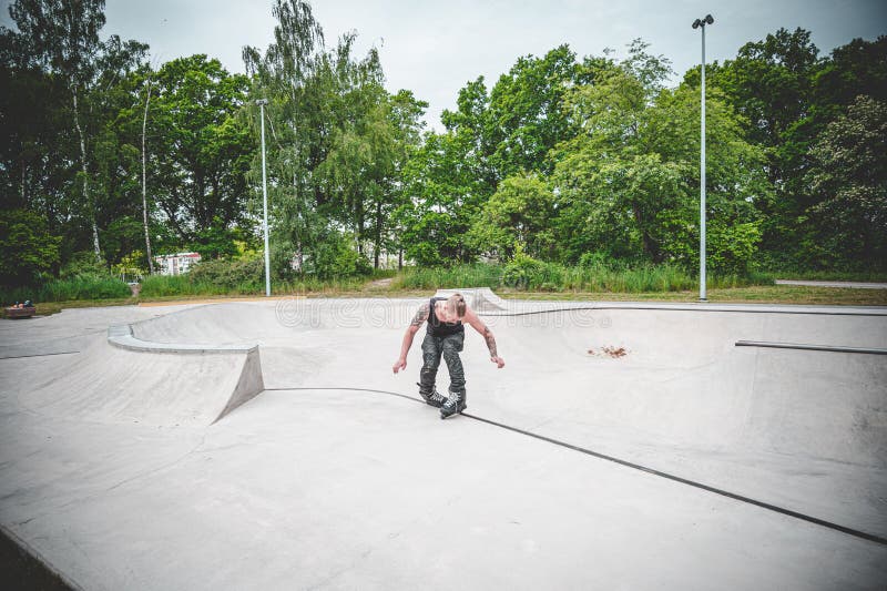 Closeup Shot of an Inline Skater in a Skating Rink Practicing Moves ...