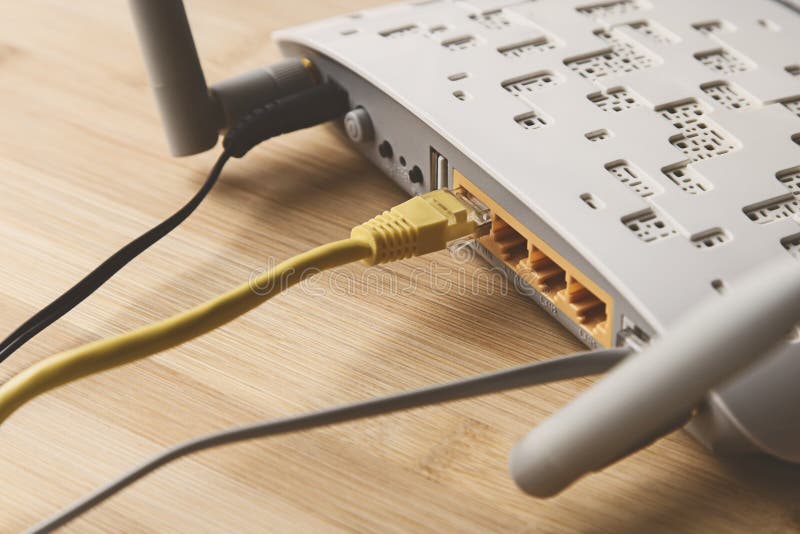Closeup Shot of an Internet Modem with a Cable on a Wooden Surface ...