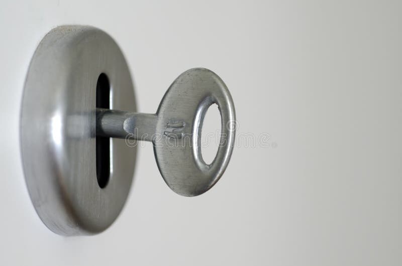 Closeup Shot of a Keyhole with a Key on the White Door Stock Image ...