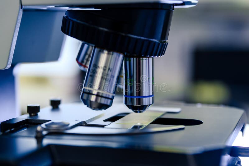 Closeup Microscope Lens on Gray Background in Laboratory Stock Photo ...