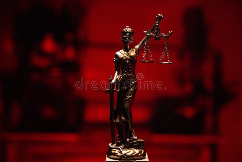 Closeup Shot of Lady Justice Bronze Statue Isolated on a Red Background ...