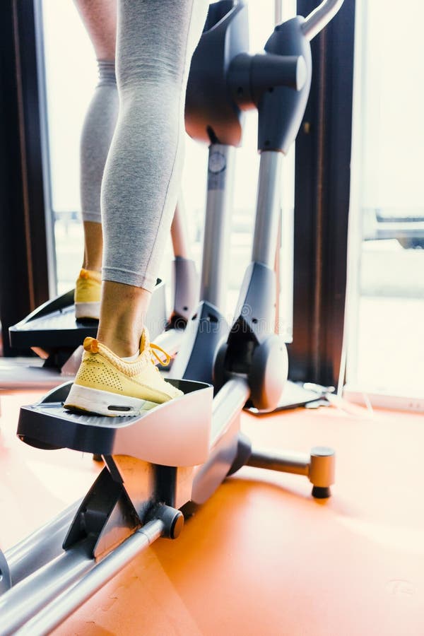 Closeup Shot of Legs of a Female Using Elliptical Trainer Stock Image ...