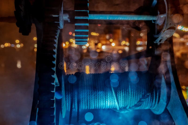 Closeup Shot of a Lifting Mechanism Cable with Bokeh Lights in the ...