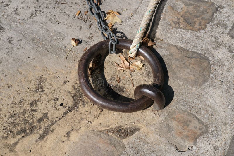Closeup Shot of a Loop Ring Placed on the Ground with Chains and Ropes ...