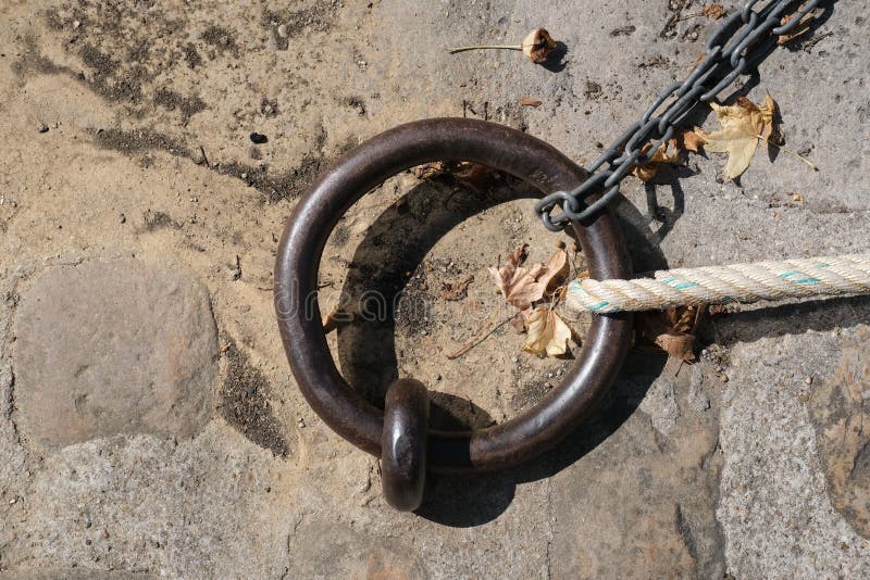 Closeup Shot of a Loop Ring Placed on the Ground with Chains and Ropes ...