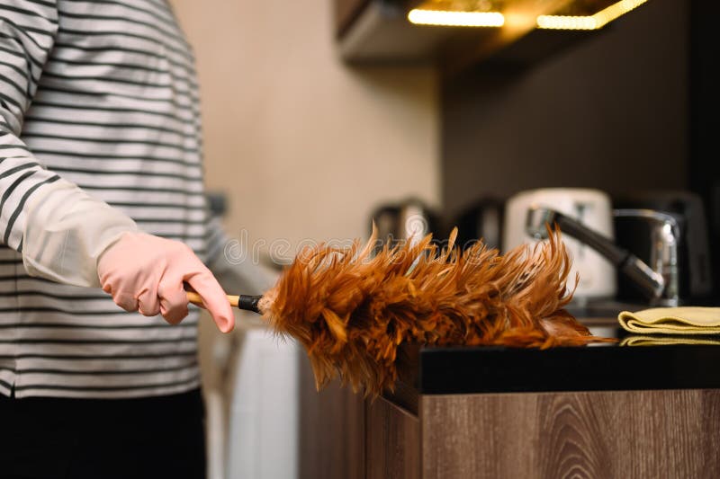 Closeup Shot of Man Dusting Kitchen with a Feather Duster. Housekeeping ...