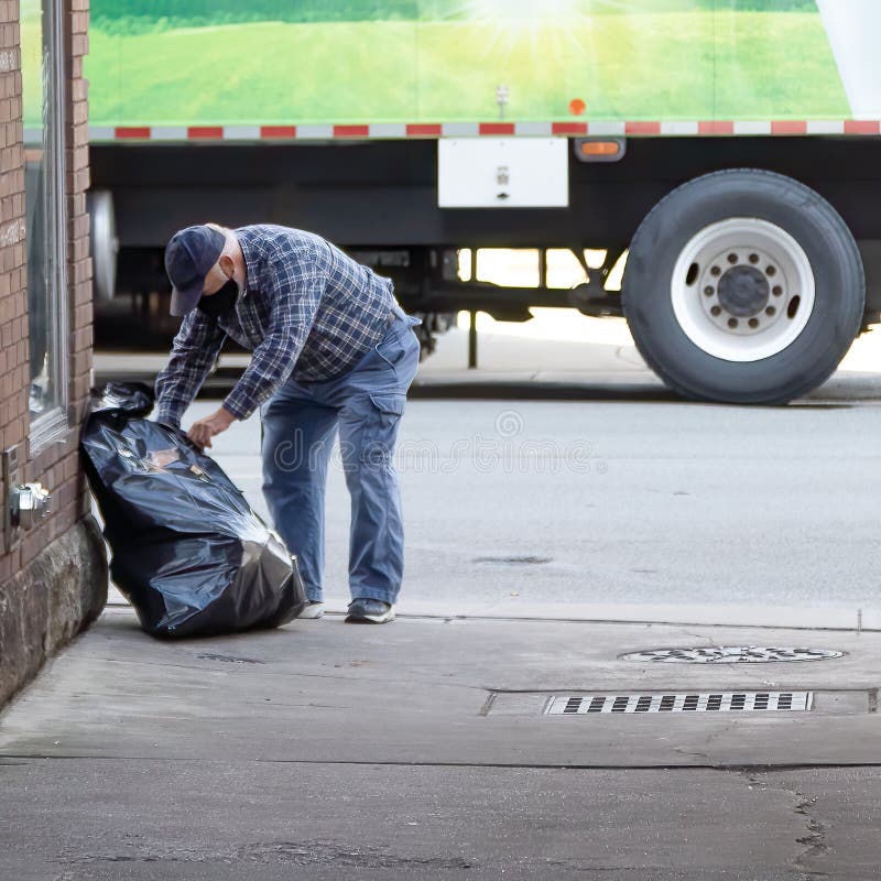 Closeup Shot of a Man Wearing a Mask Looking through the Trash Stock ...