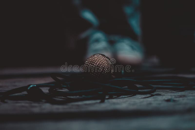 A Microphone on the Ground and Blurred Photo of Conference Hall or ...