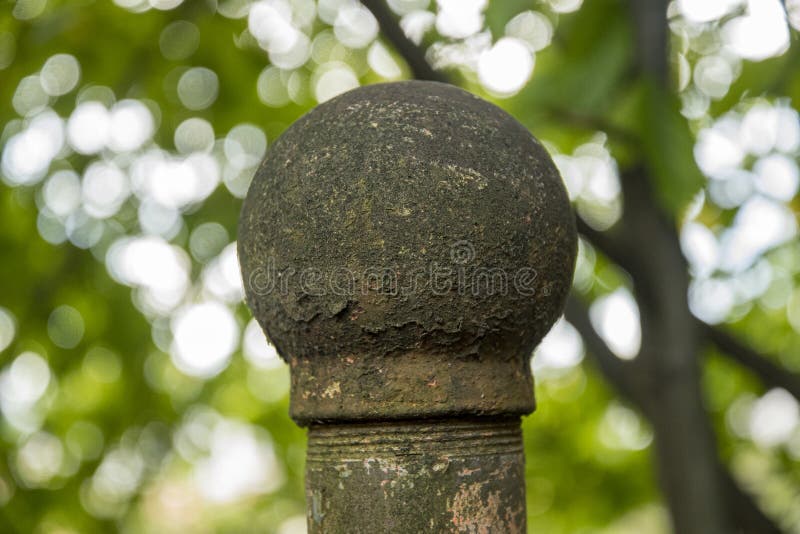 Closeup Shot of a Mossy Stone Round Column with White Bokeh Lights in ...