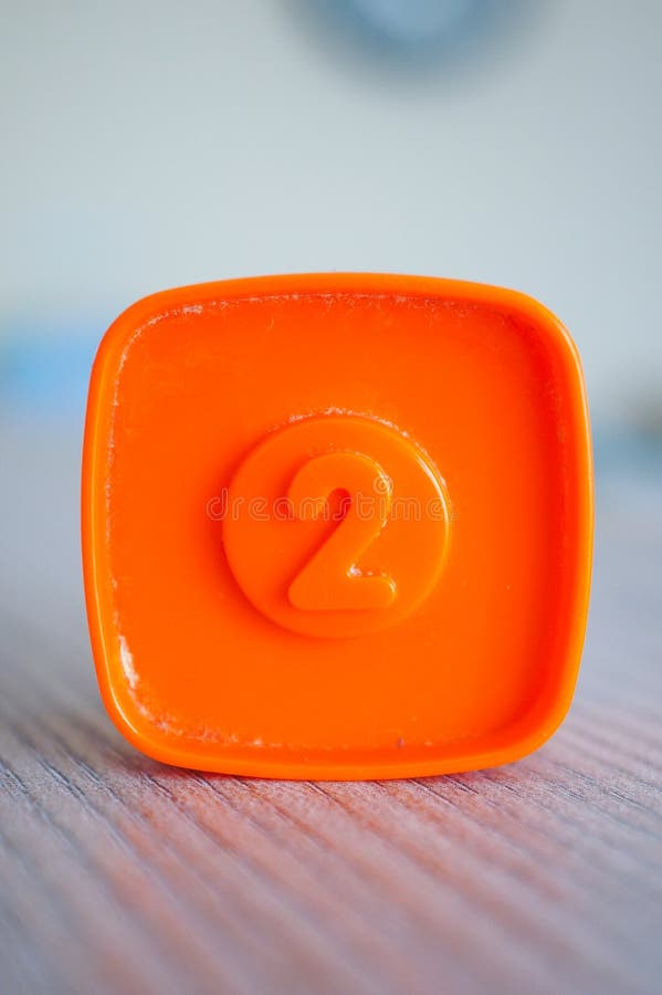 Closeup Shot of an Orange Square Plastic Toy with the Number Two on it ...