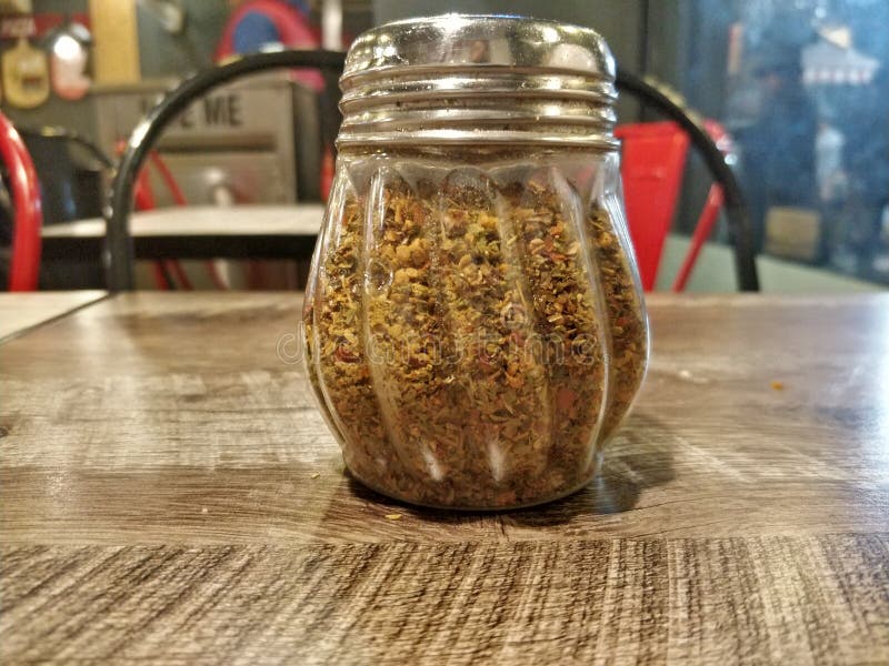 Closeup Shot of Oregano and Chilli Flakes on Table Stock Photo - Image ...