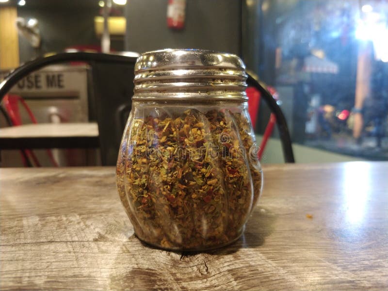 Closeup Shot of Oregano and Chilli Flakes on Table Stock Image - Image ...