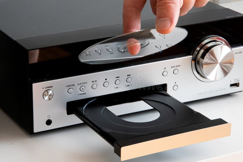 Closeup Shot of a Person S Hand Inserting a CD Disk To Home Stereo ...
