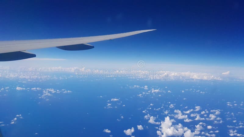 Closeup Shot of a Plane Wing in Flight Under Blue Sky Stock Image ...