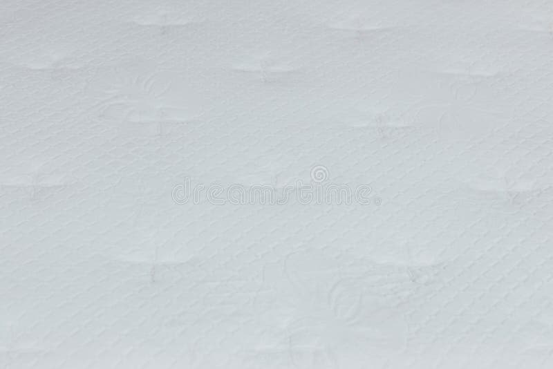 Closeup Shot of a Quilted White Mattress with Soft Flowers Pattern ...