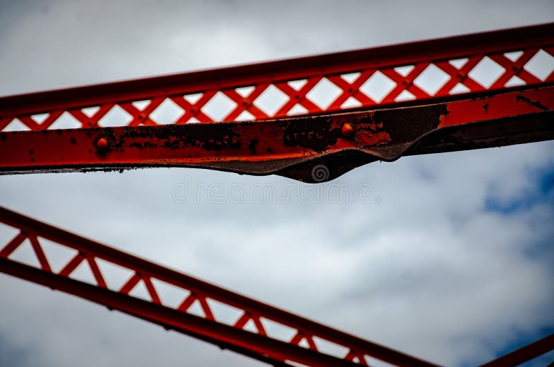 Closeup Shot of a Red Iron Bridge on a Cloudy Day Background Stock ...