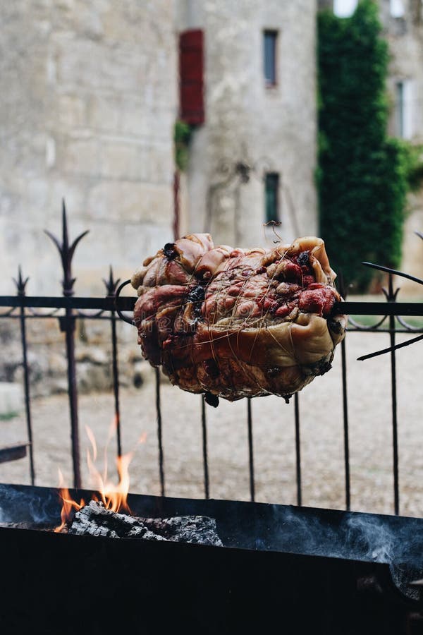 Closeup Shot Of Roasting Meat On A Spit With Fire On The Background