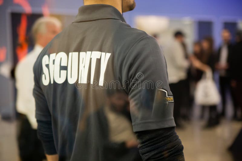Closeup Shot of a Security Guard Inside a Commercial Building with ...