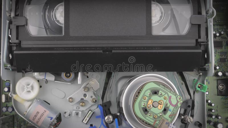 Closeup Shot Showing Inside of a Vcr while a Vhs Cassette is Being ...