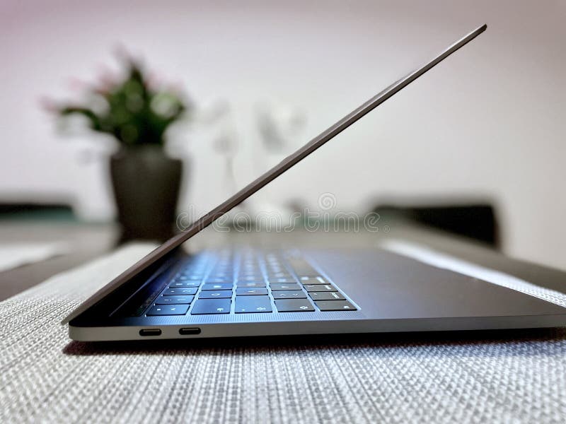 Closeup Shot of a Side View of a Personal Computer. Laptop Half-open ...