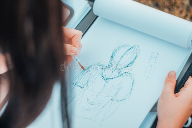 Closeup Shot of a Sketchbook with a Drawing of a Figure. Stock Photo ...