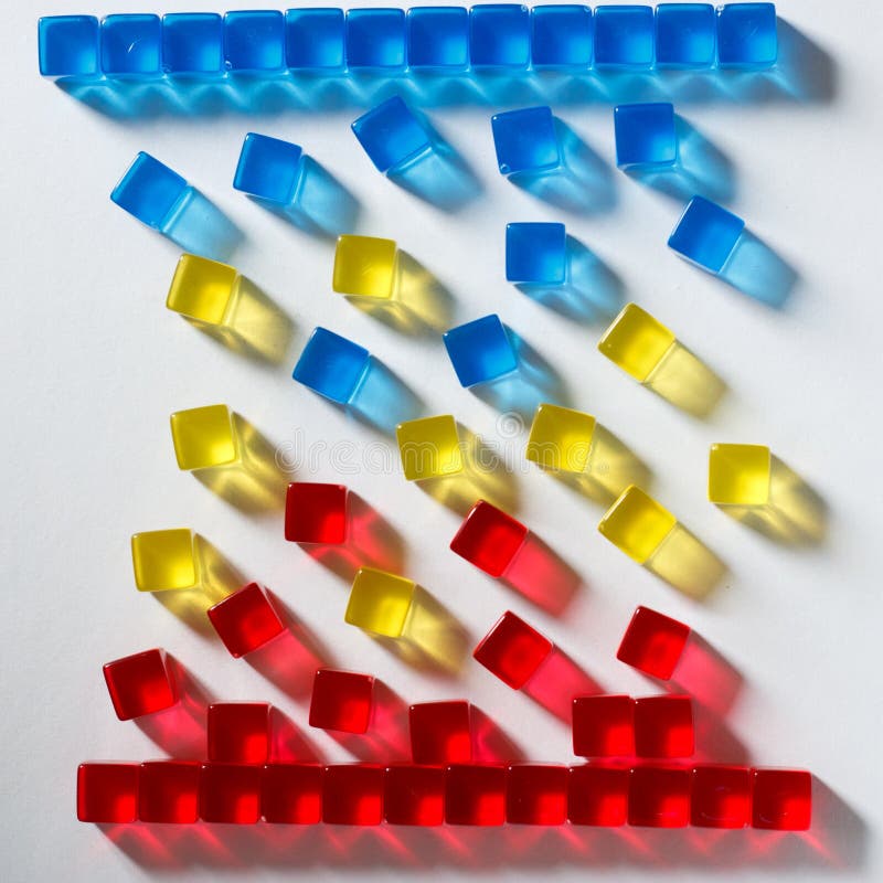 Closeup Shot of Small Red, Blue, and Yellow Square Crystals on a Grey ...