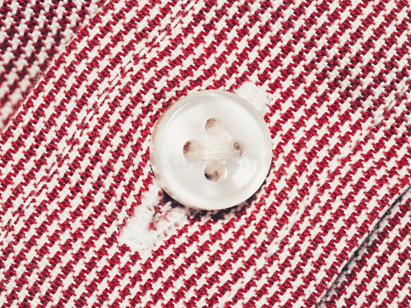 Closeup Shot of a Small White Button Sewn Onto a Red Patterned Fabric ...
