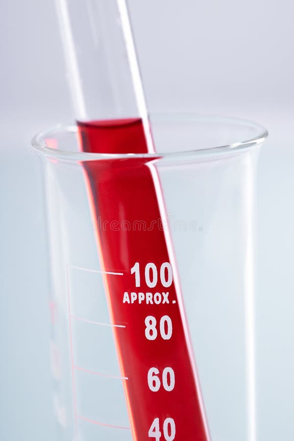 Closeup Shot of a Test Tube with Red Liquid Inside a Beaker on a White ...